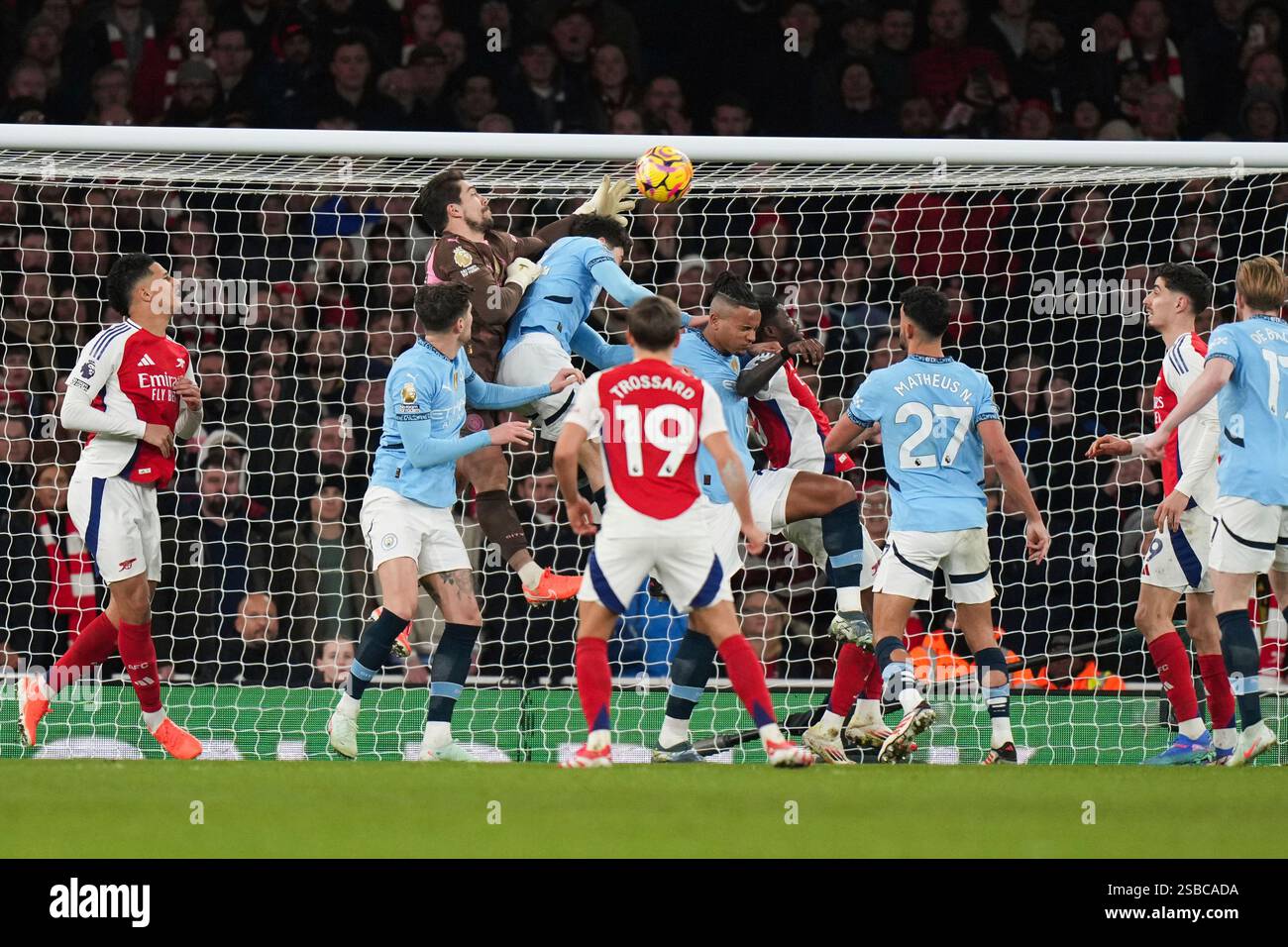 Manchester City's goalkeeper Stefan Ortega, top left, clears the ball ...