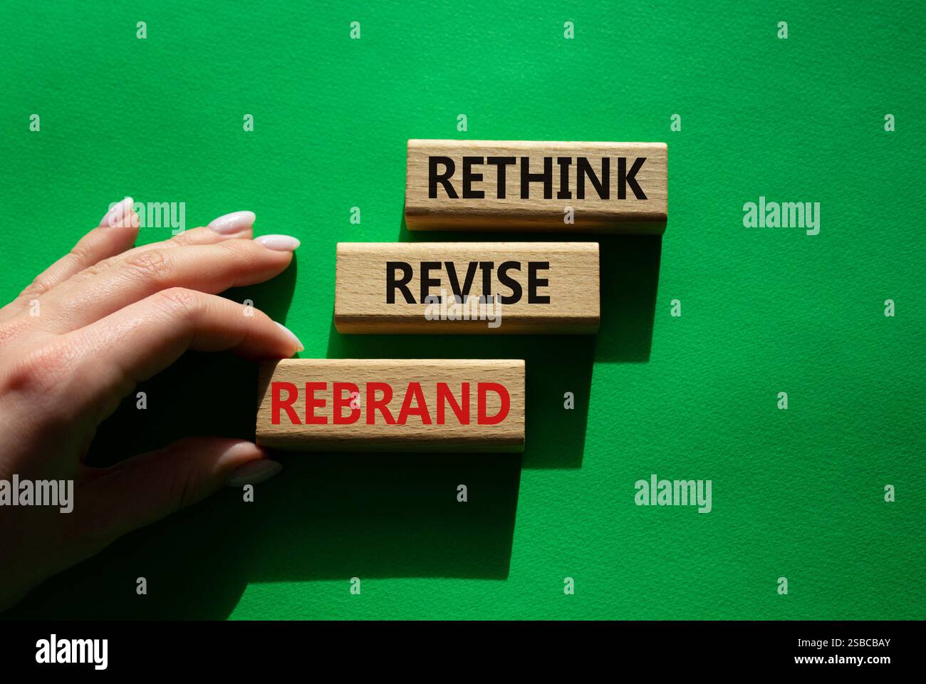 Rethink Revise Rebrand symbol. Wooden blocks with words Rethink Revise Rebrand. Beautiful green ...