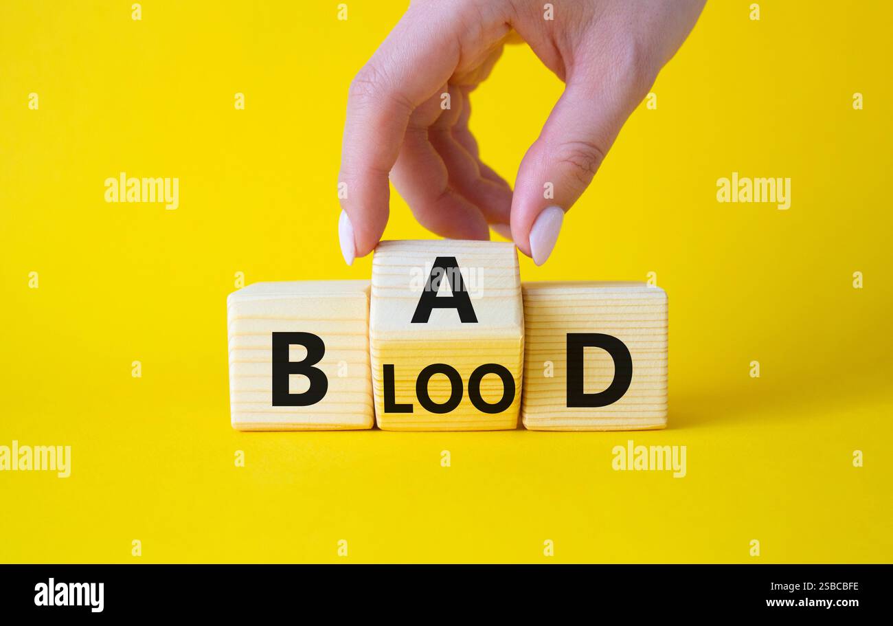 Breed Bad Blood symbol. Businessman hand turns wooden cubes with words ...