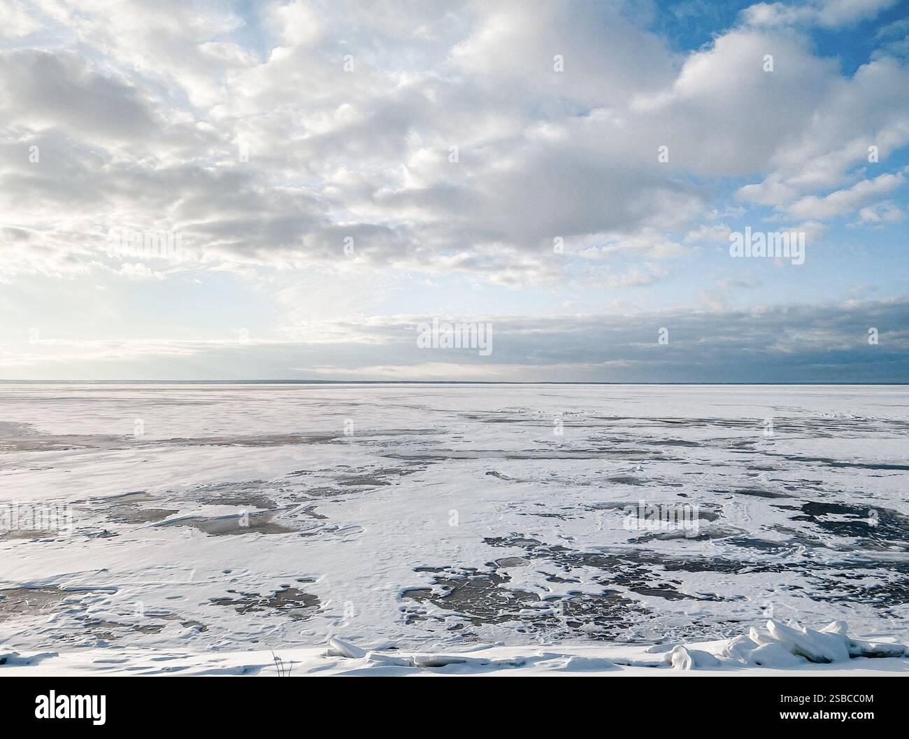 Bright sun shining over over the frozen sea. Winter seascape: clouds ...