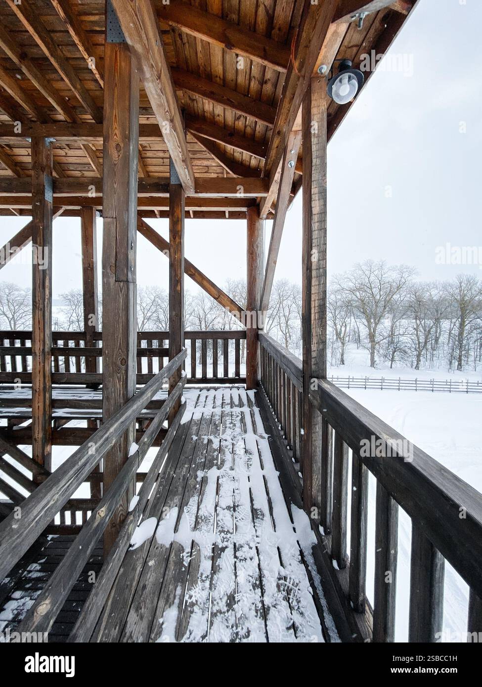 Fire lookout tower in winter countryside. Upper level of a wooden watch ...