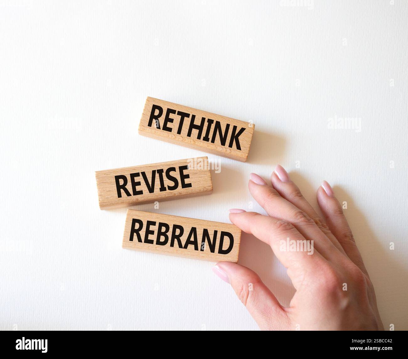 Rethink Revise Rebrand symbol. Wooden blocks with words Rethink Revise Rebrand. Beautiful white ...