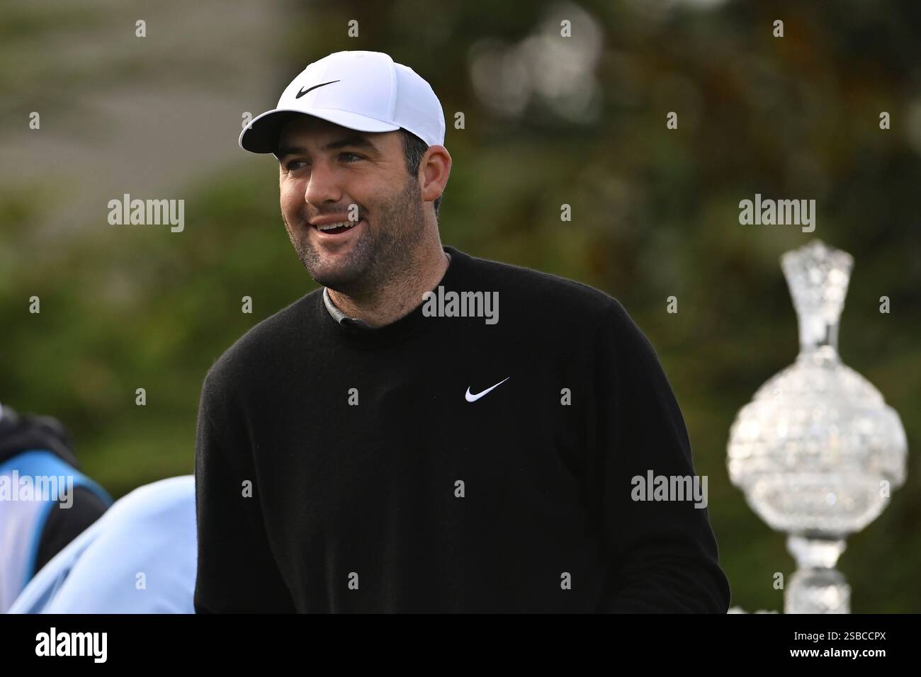 Scottie Scheffler smiles while waiting to hit from the first tee at ...
