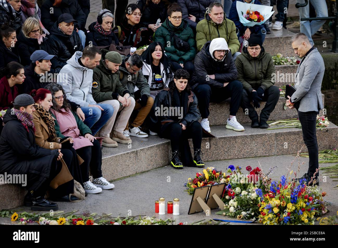 AMSTERDAM - Relatives and friends hold a moment of silence during a ...