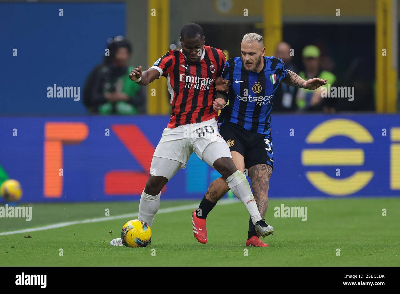 Milan, Italy. 2nd Feb, 2025. Yunus Musah of AC Milan shields the ball from Federico Dimarco of ...
