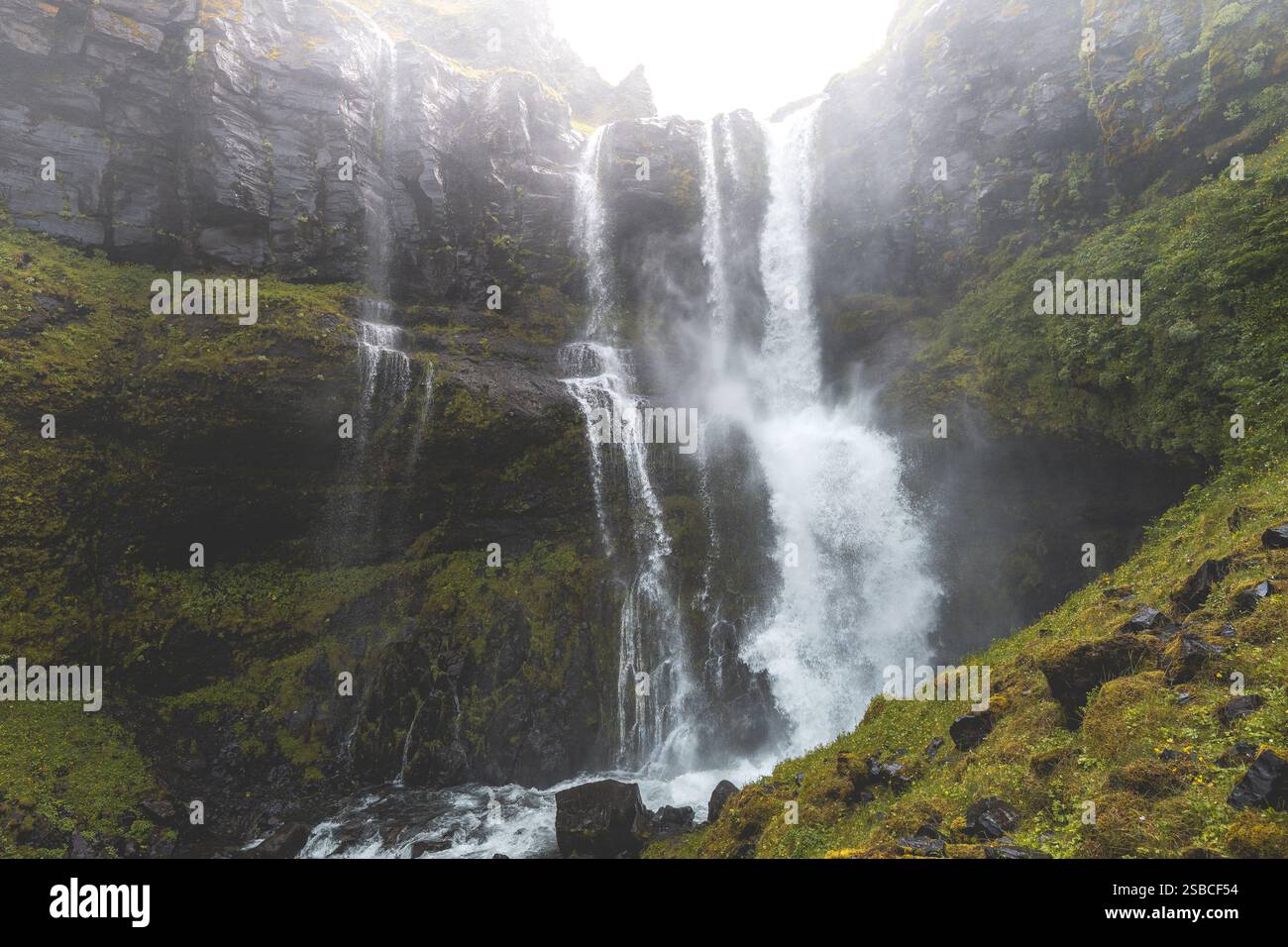 Mesmerizing waterfall cascades down moss-covered rocks on the ...