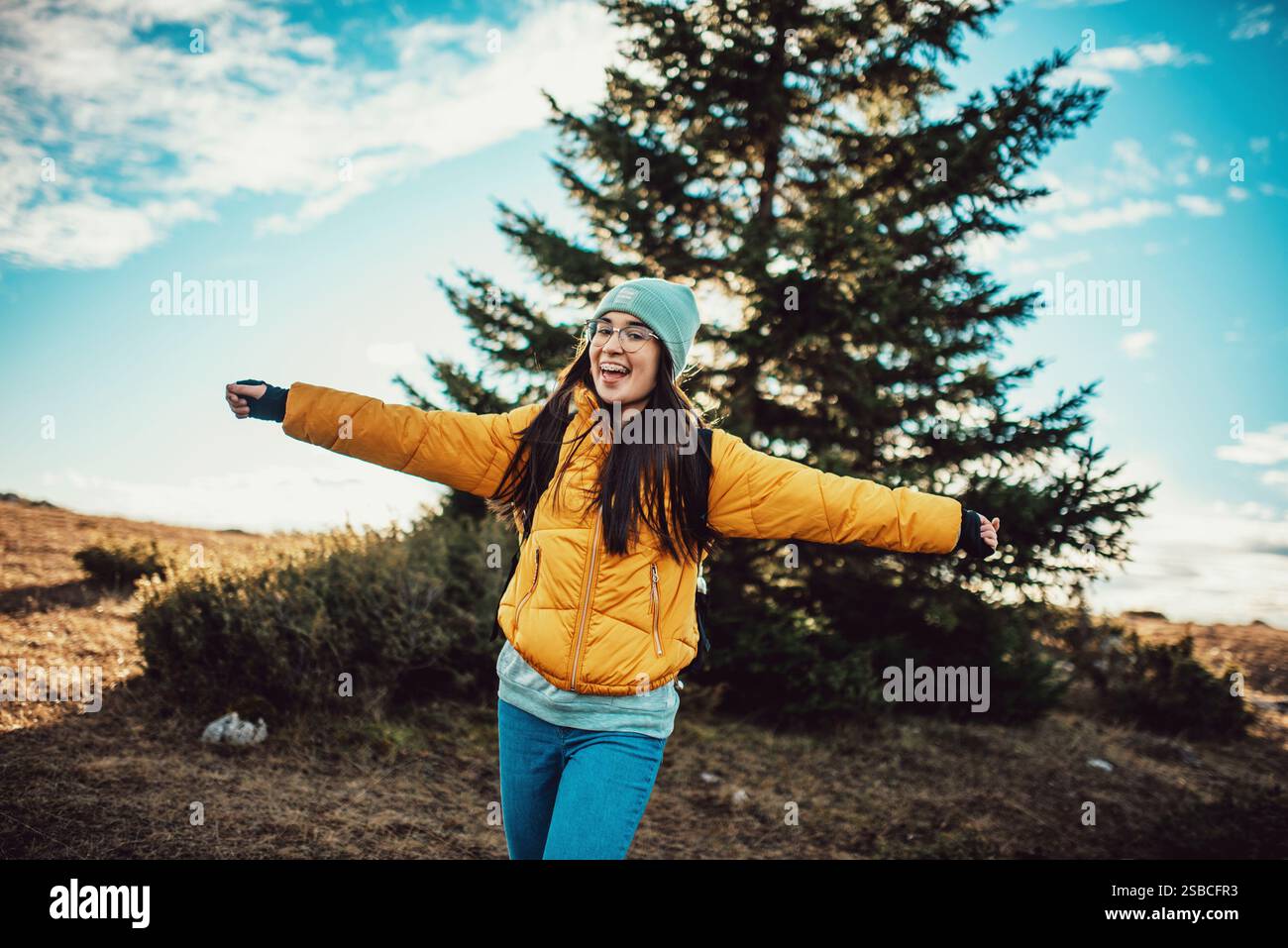 a woman with outstretched arms running through nature Stock Photo - Alamy