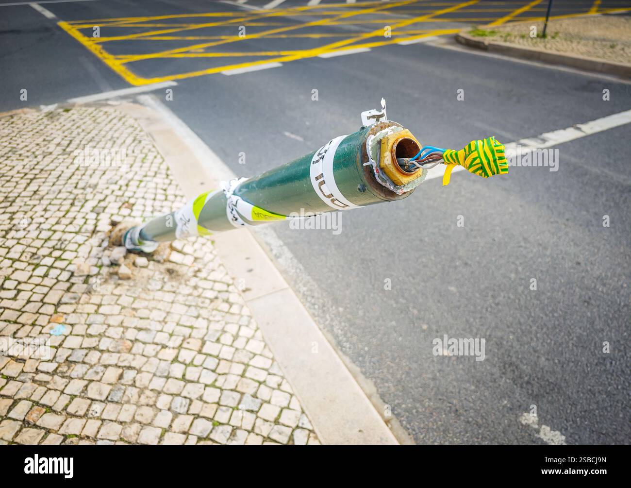 Leaning pole with protruding wires and messy electrical wiring on a ...