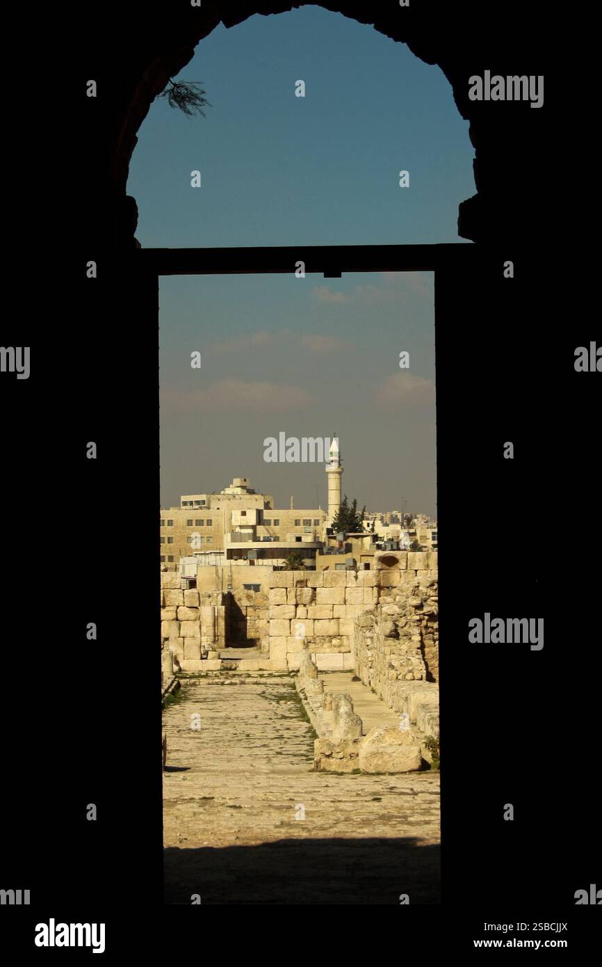 Dark archway of a Byzantine church in Amman frames the bright, sunlit ...