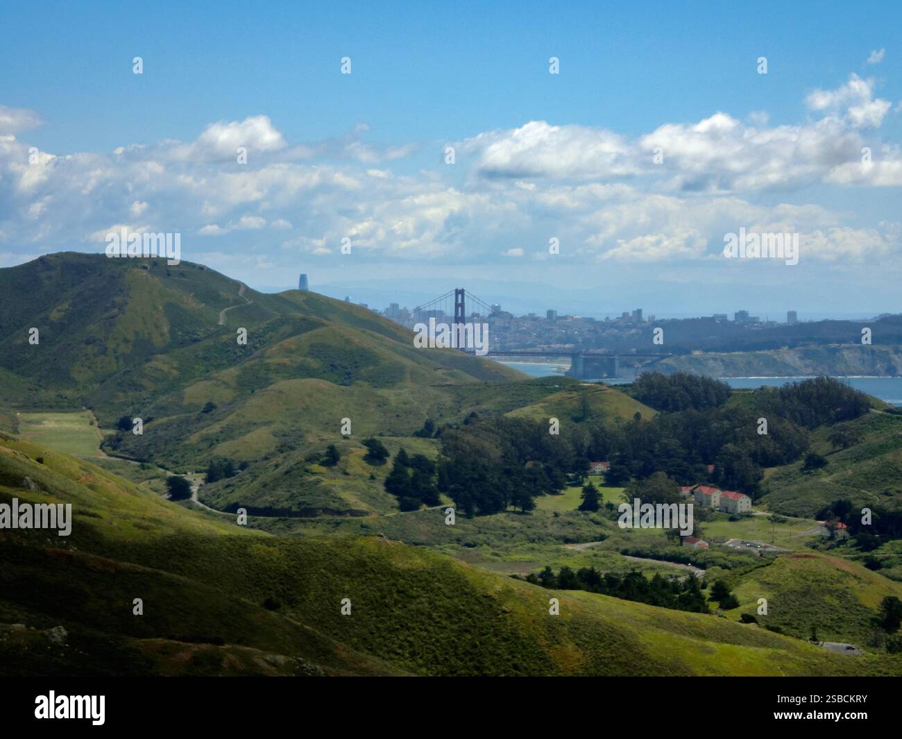 Green hills of Marin Headlands with tower of Golden Gate Bridge and ...