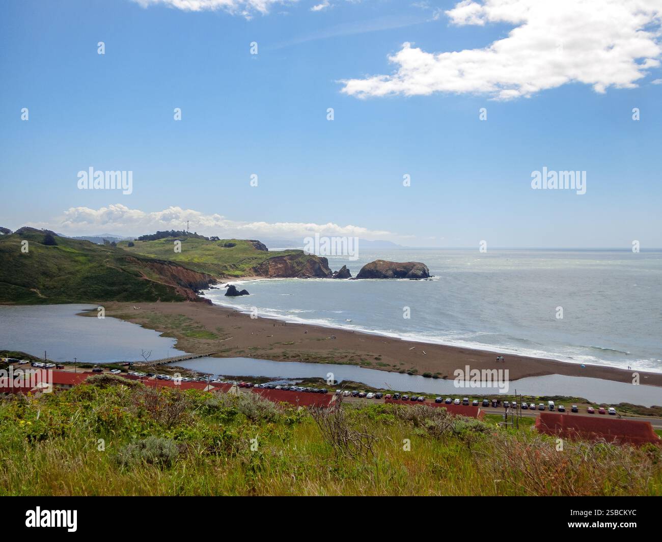 Rodeo Beach and rocky shoreline in Marin Headlands on clear blue sky ...