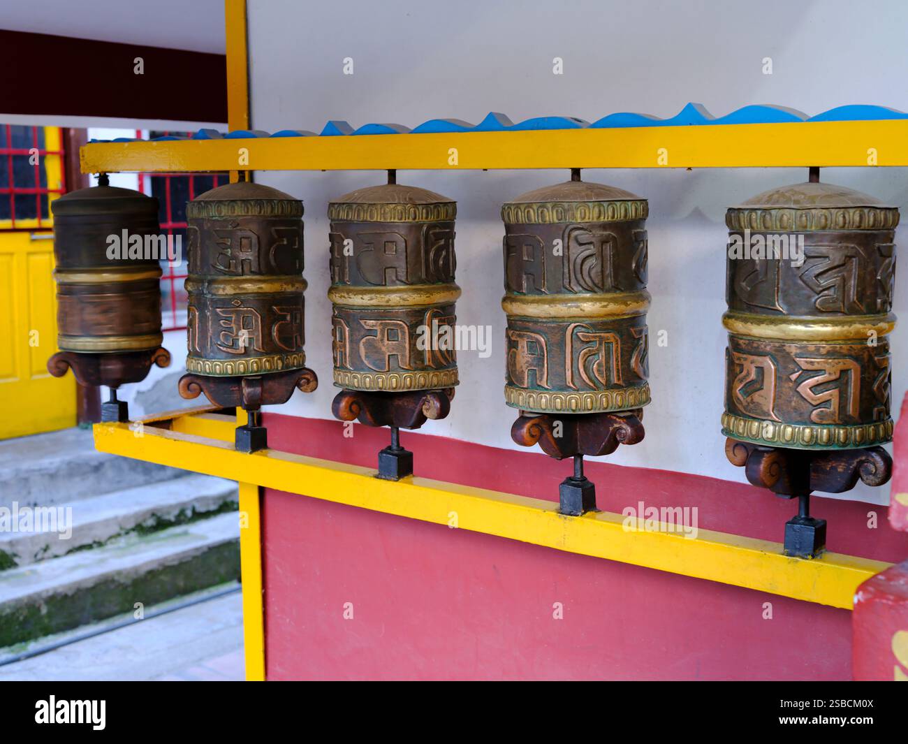 Prayers wheels or mani wheels at the entrance of a Buddhist shrine ...