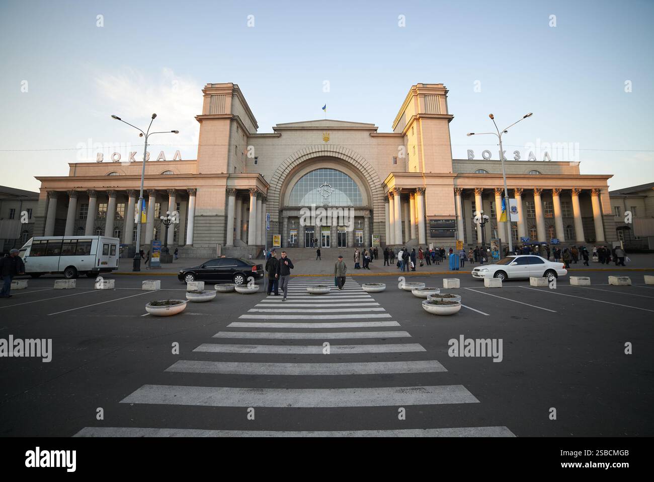 Facade of train station with people crossing, urban architecture in ...