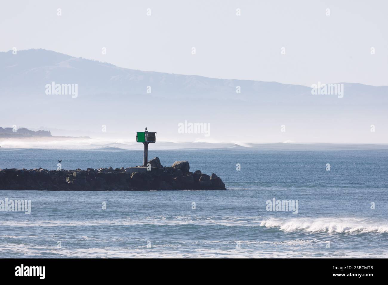 Rock jetty extends into sea spray, waves and channel maker reach into ...
