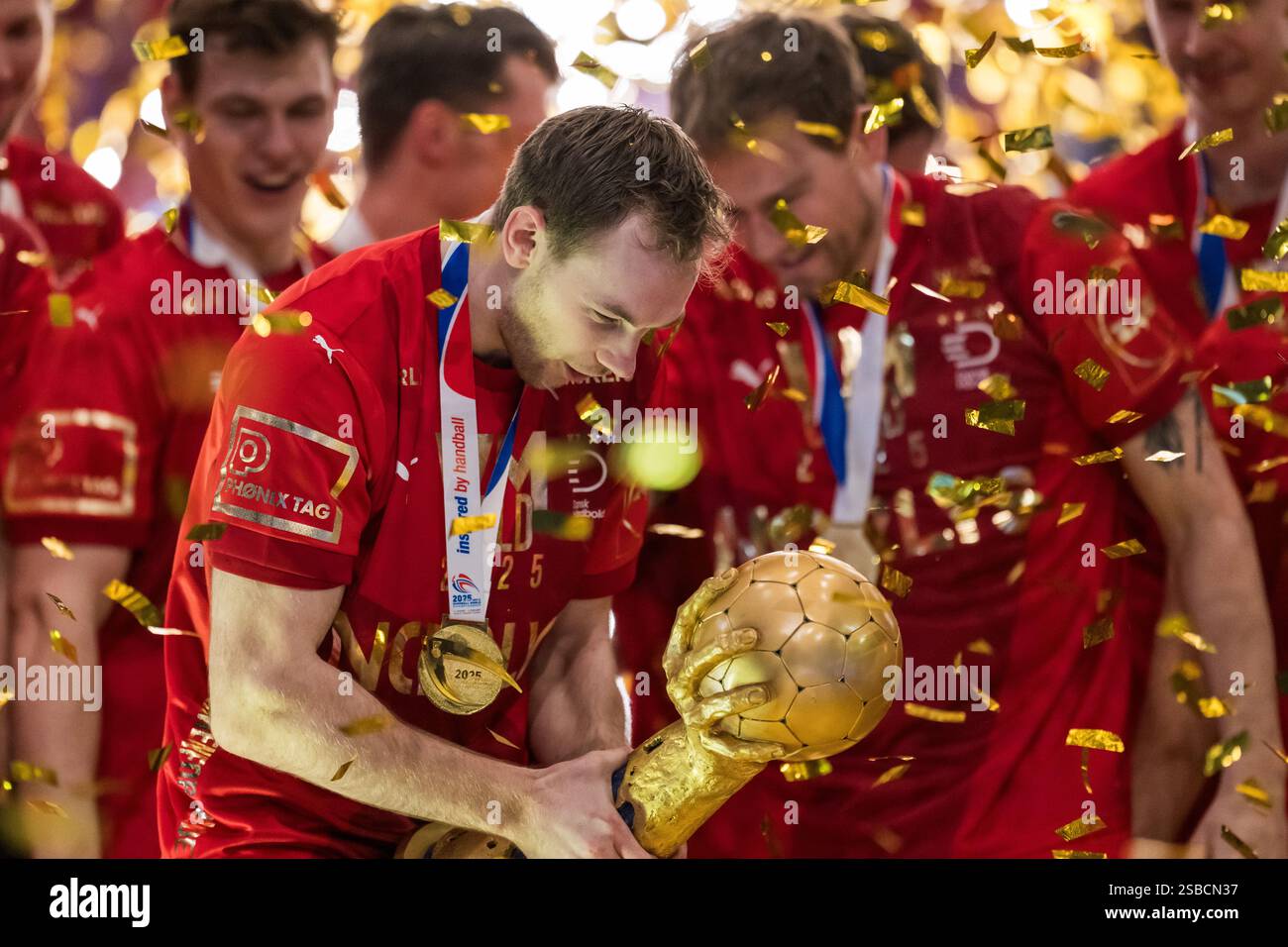 Players of, Denmark. , . celebrate with the trophy after the 2025 IHF ...