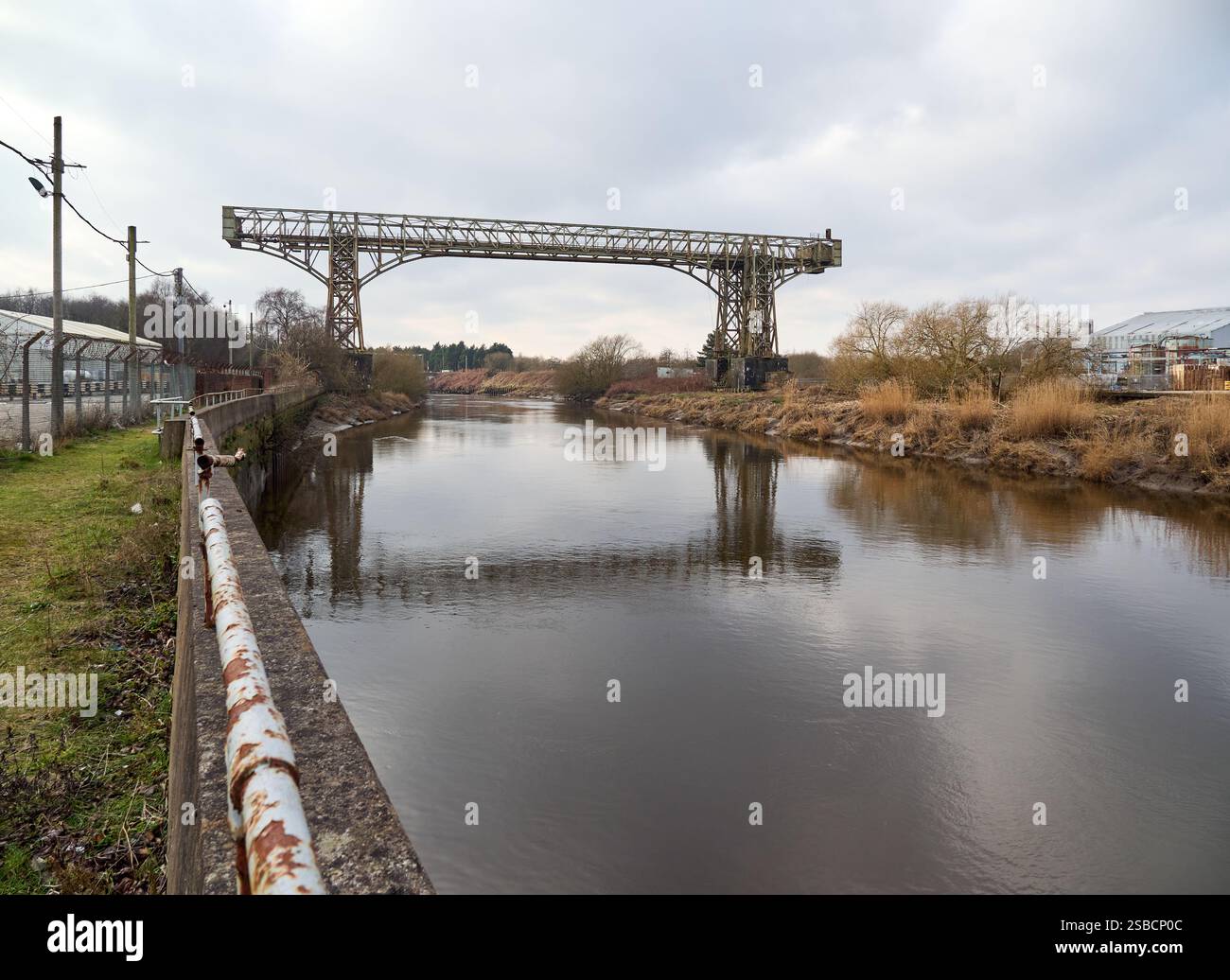 Warrington transporter bridge. Industrial gantry over a calm river ...