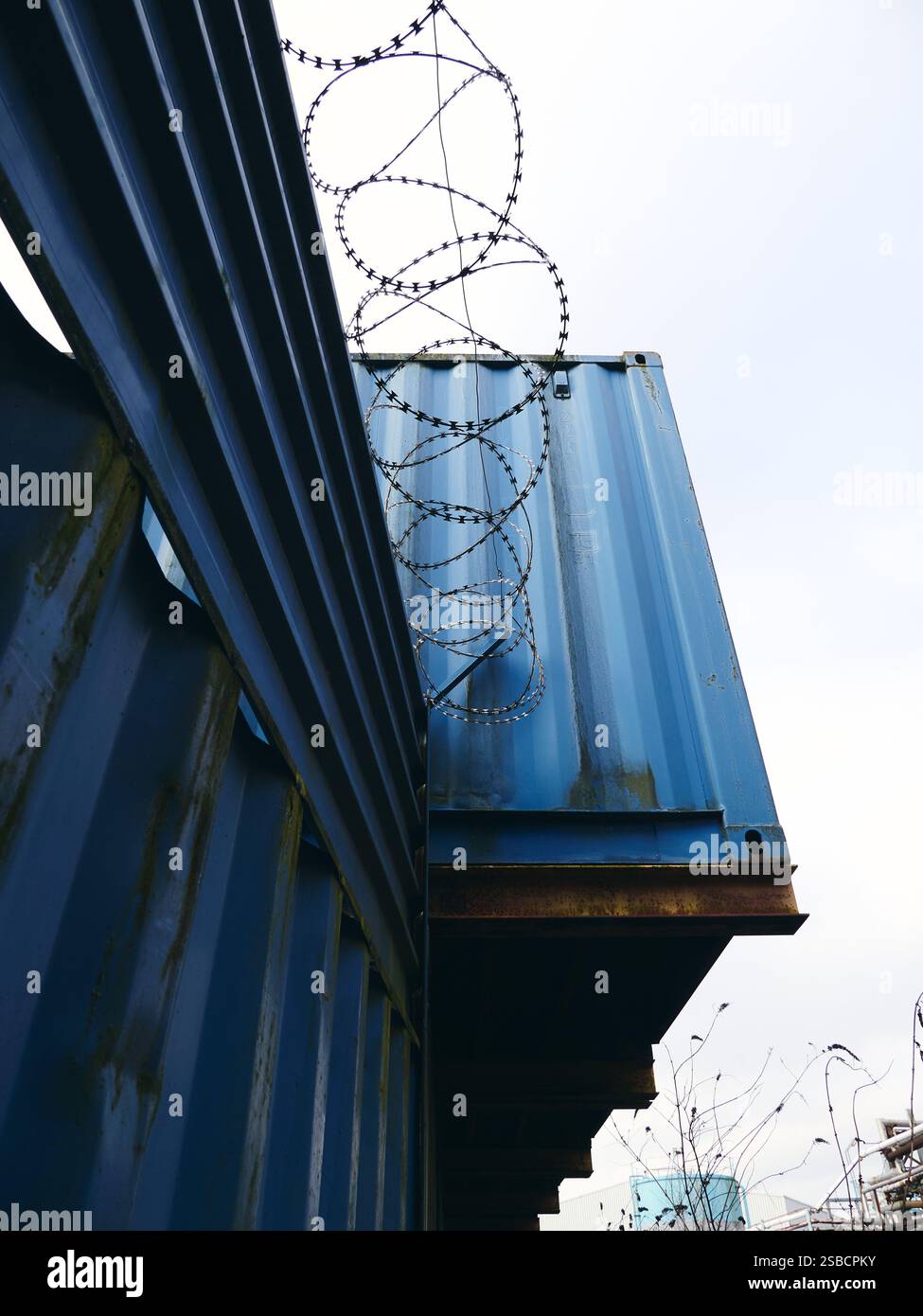 Blue shipping containers with barbed wire for security purposes Stock ...
