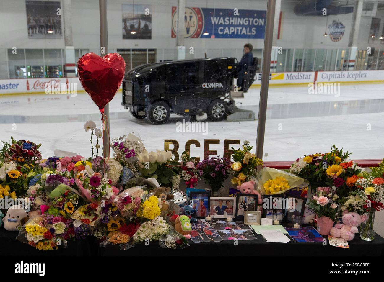 An ice resurfacer prepares the ice as a memorial is seen along the ...
