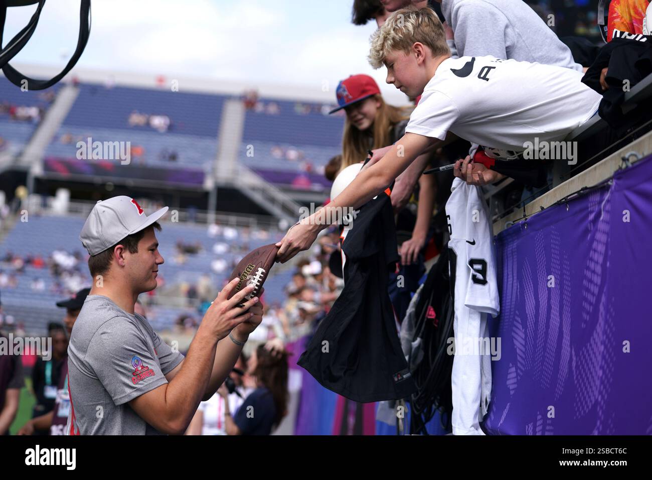 AFC quarterback Drake Maye, of the New England Patriots, signs ...