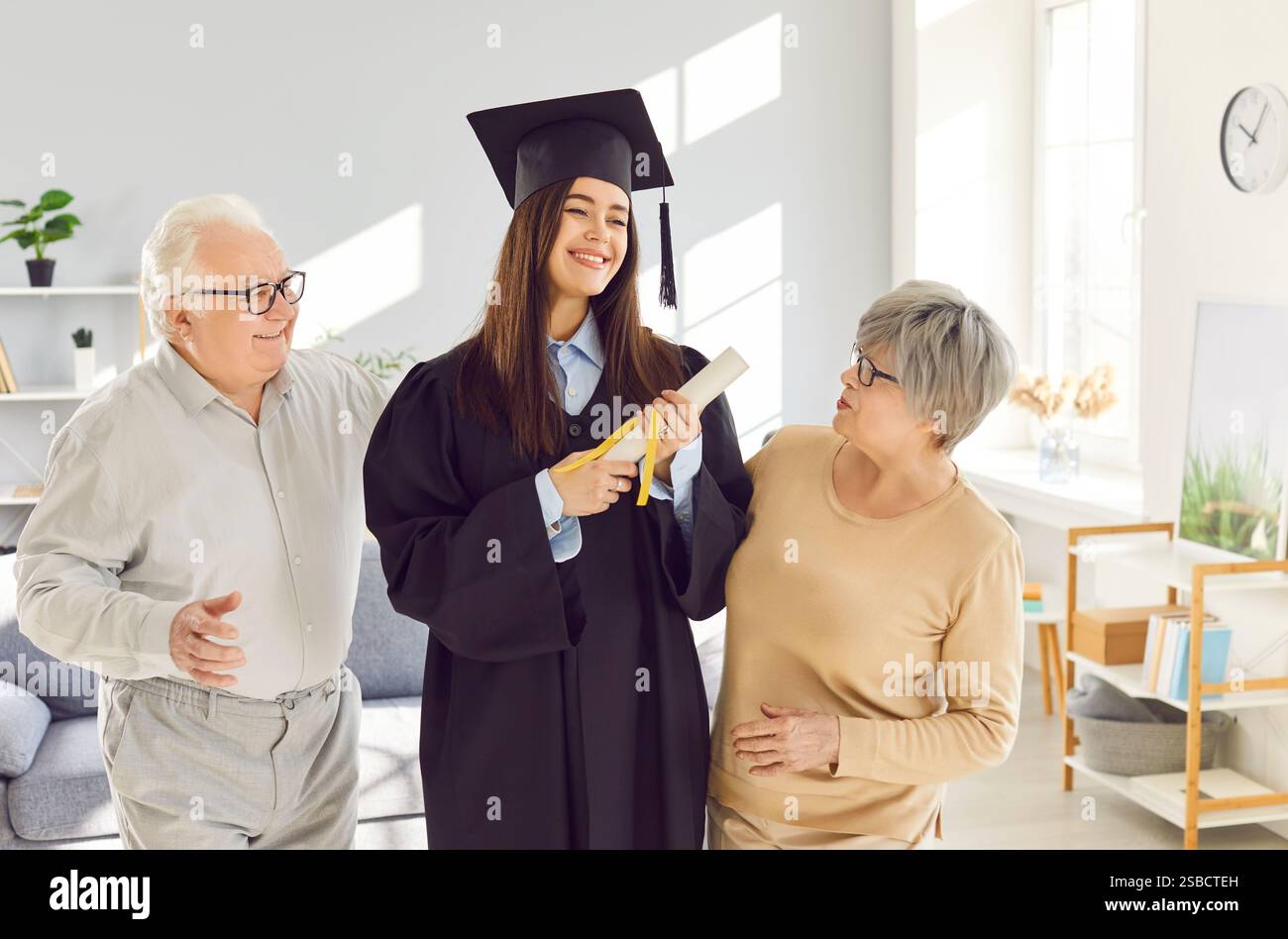 Proud Elderly Parents Congratulating Daughter With University Graduate ...