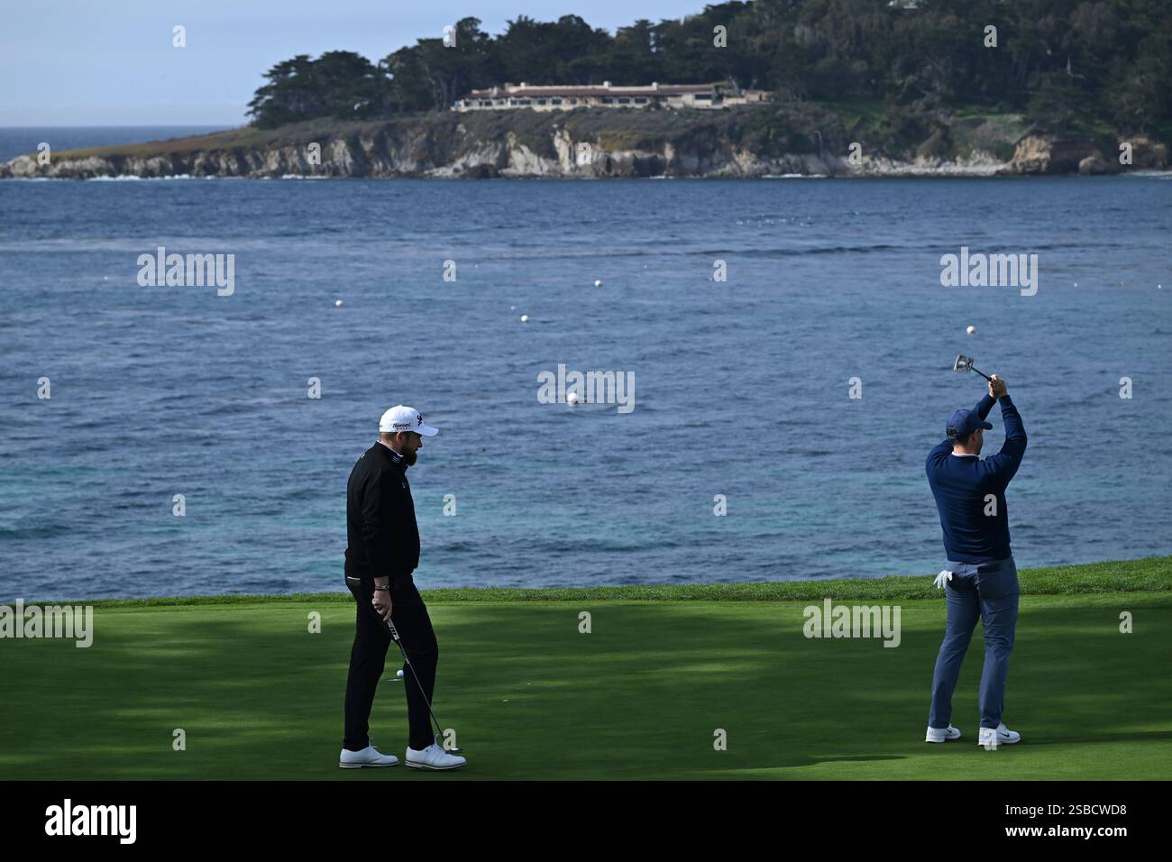 Rory McIlroy, of Northern Ireland, right, reacts to missing a putt on the fifth hole next to ...