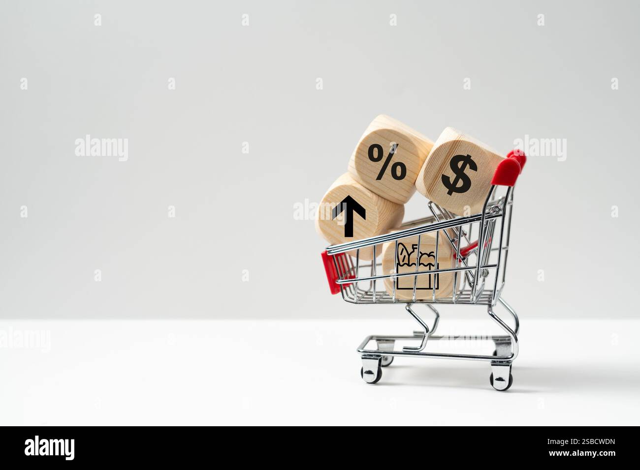 Grocery shopping cart filled with wooden blocks labeled with inflation ...