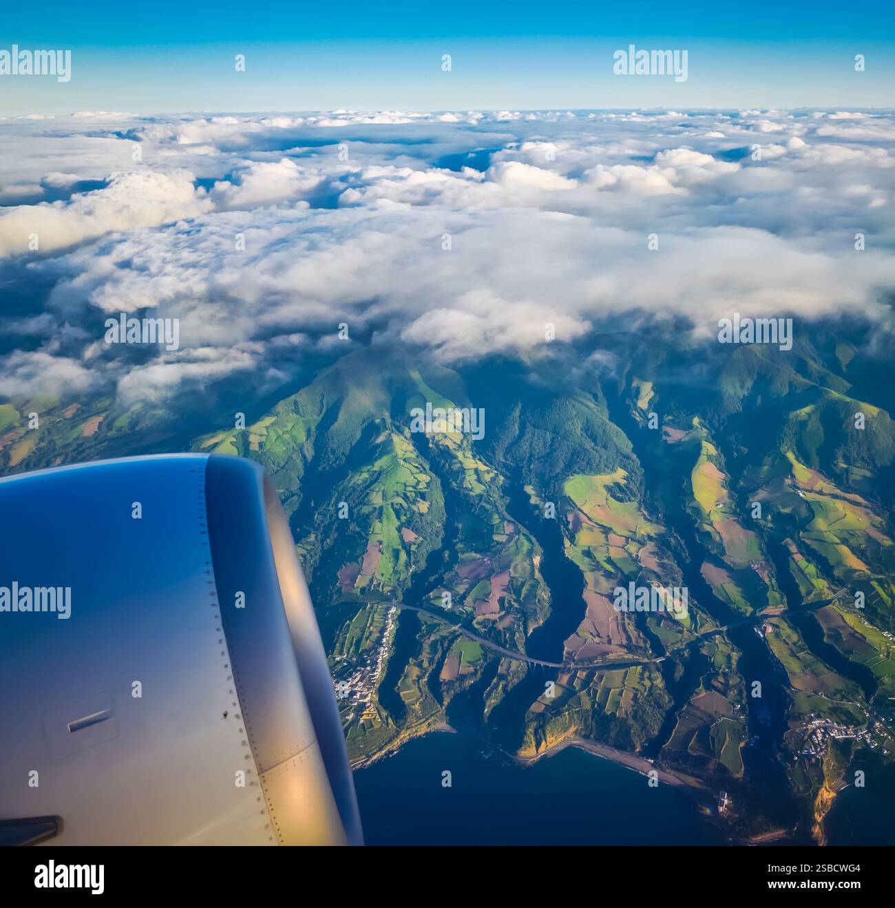 View of a tropical island in the middle of ocean from a plane window ...