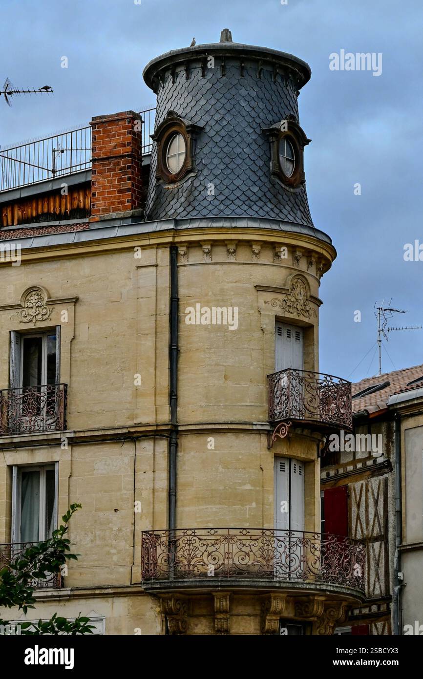 A historic French building with a distinctive circular tower, ornate ...