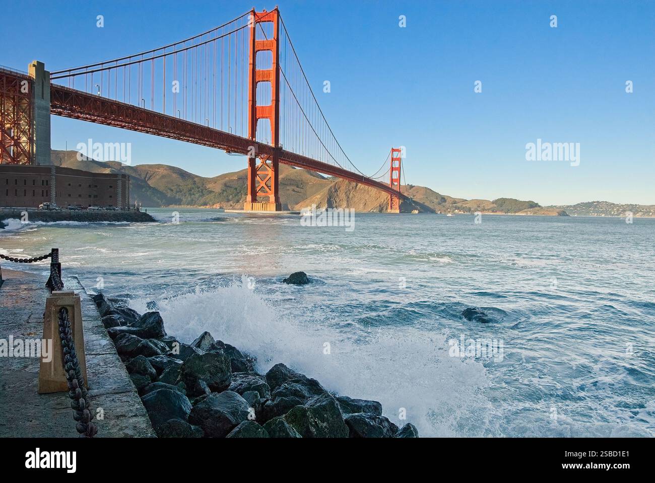 Waves crash against riprap abutment at Fort Point under the Golden Gate ...