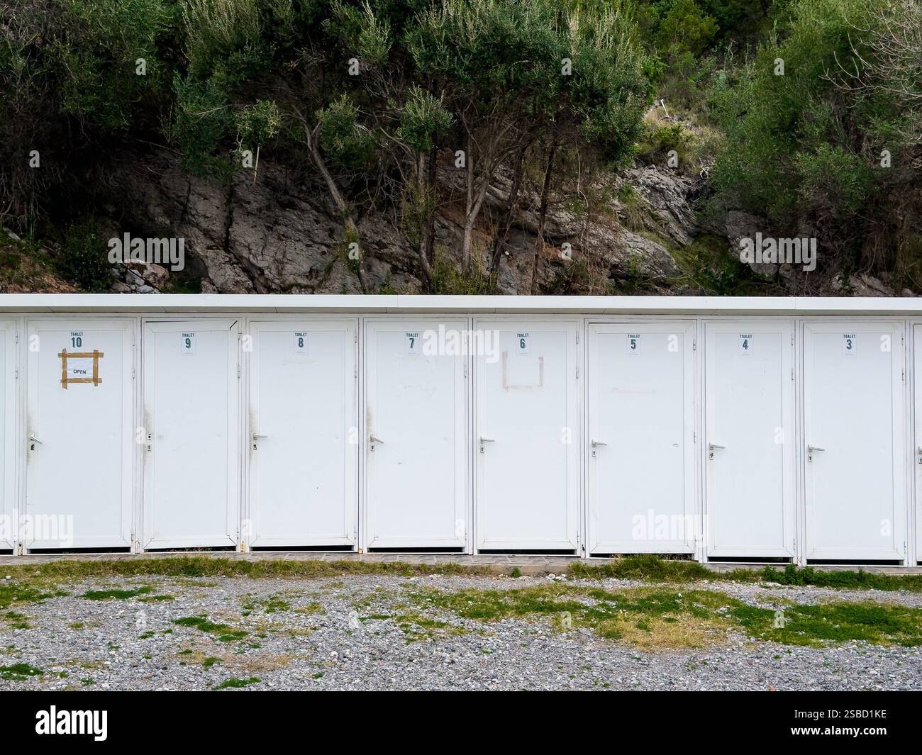 Row of White Public Toilets in Nature Stock Photo - Alamy