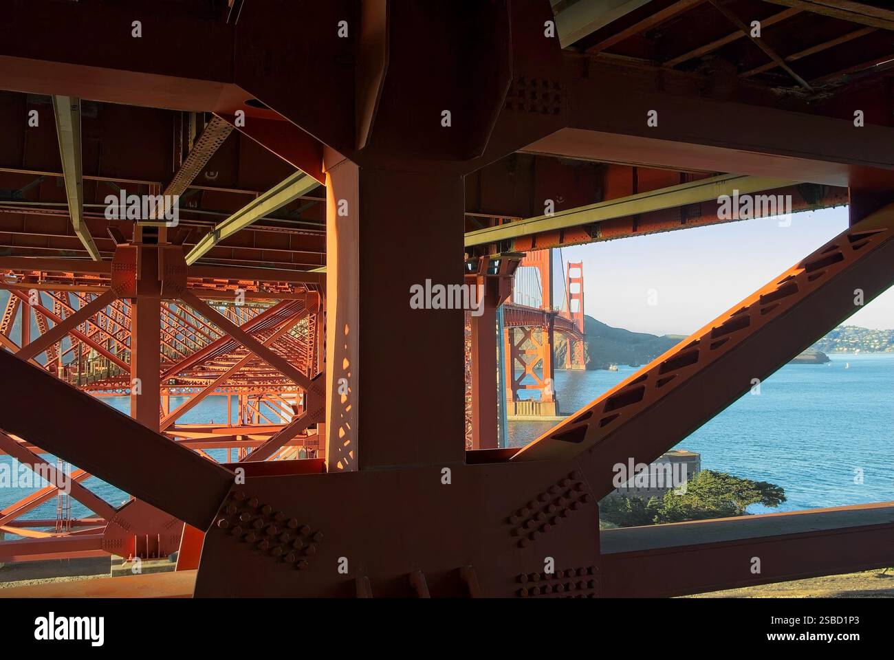 Golden Gate towers viewed through steel truss work beneath road deck ...