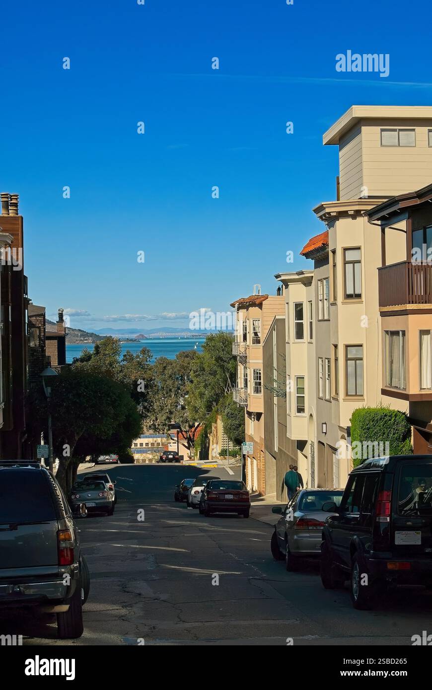 Residential row houses line street sloping downward to San Francisco ...