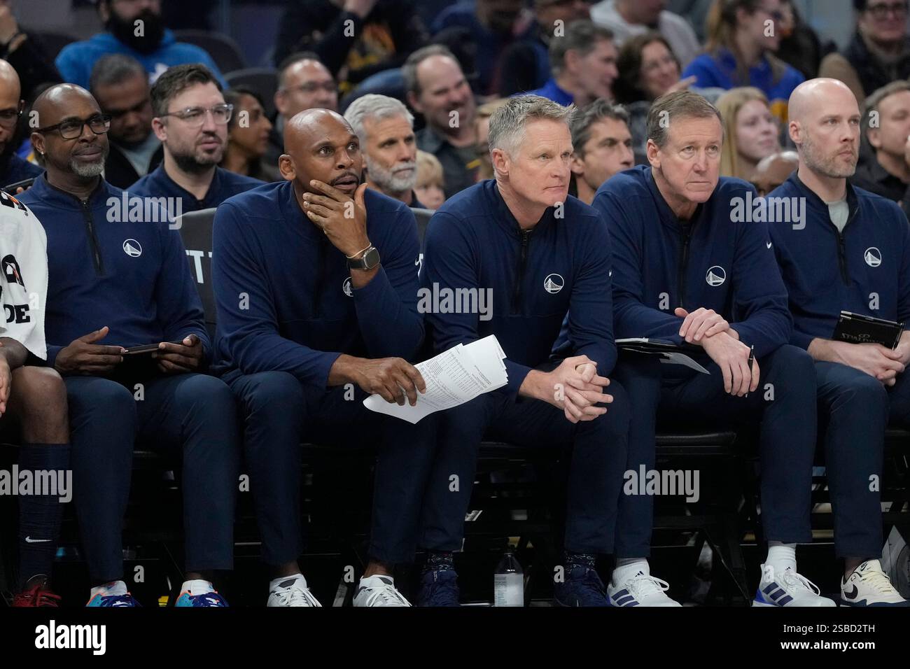 Golden State Warriors head coach Steve Kerr, middle, sits with assistant coaches Kris Weems ...