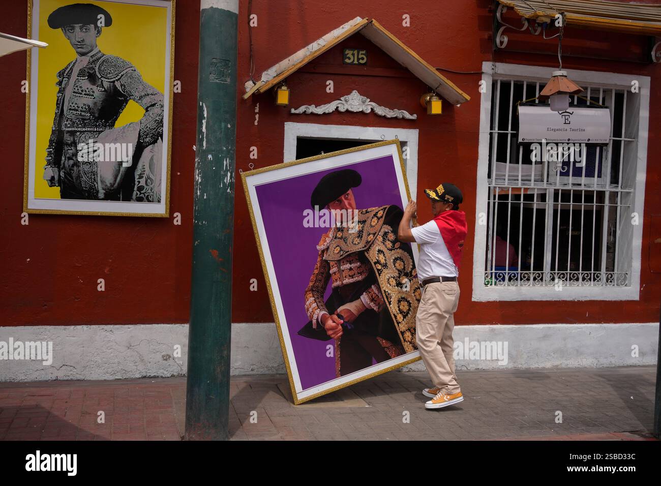 Antonio Flores carries a drawing of Peruvian bullfighter Andres Roca ...
