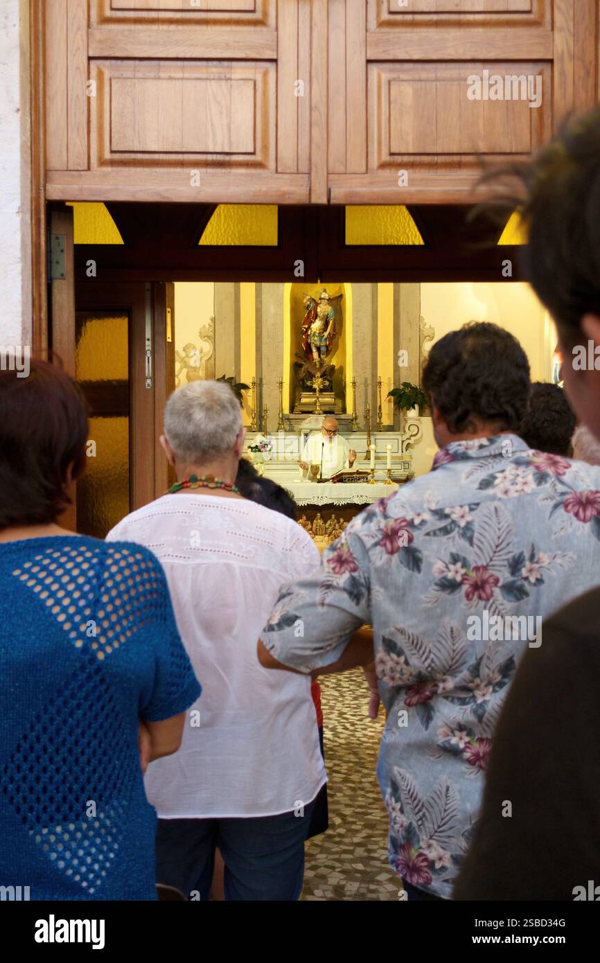 faithful participate in the holy mass praying outside the crowded ...