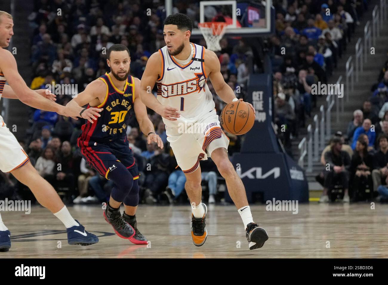 Phoenix Suns guard Devin Booker (1) drives to the basket against Golden State Warriors guard ...