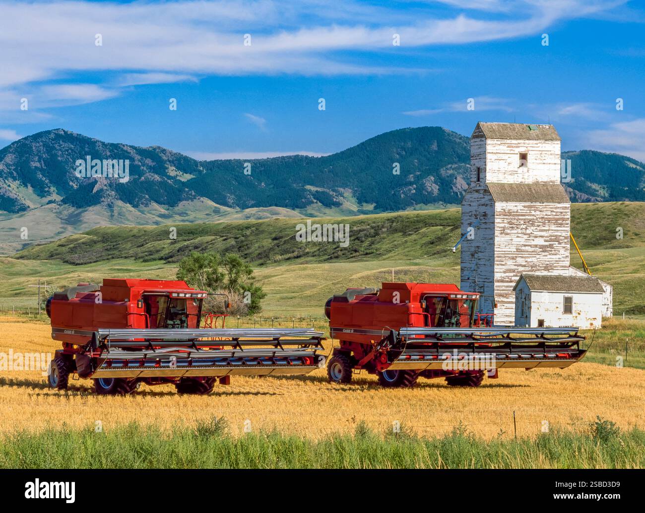 combines and grain elevator below the highwood mountains near highwood ...