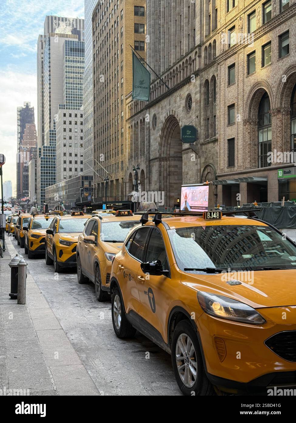 Taxi cabs lined up to pick up passengers along 42nd Street in front of ...
