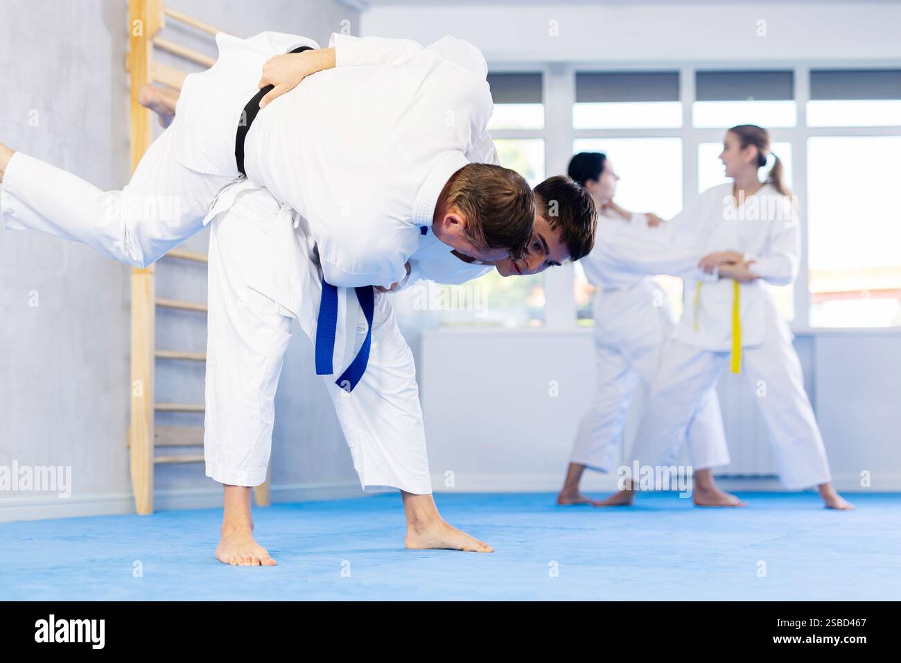 Adult man and young guy training judo techniques Stock Photo - Alamy