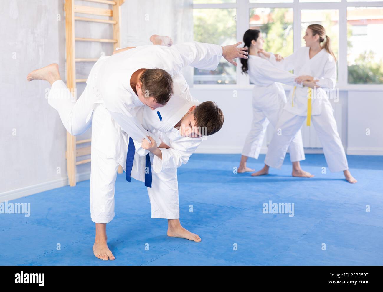 Adult man and young guy training judo techniques Stock Photo - Alamy