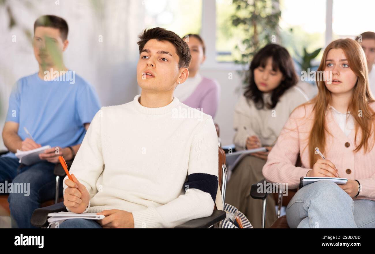 Teenager students listening in classroom school Stock Photo - Alamy