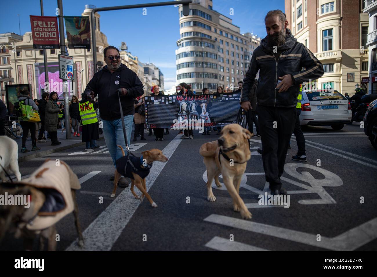 Animal rights activists march with banners alongside their dogs during ...
