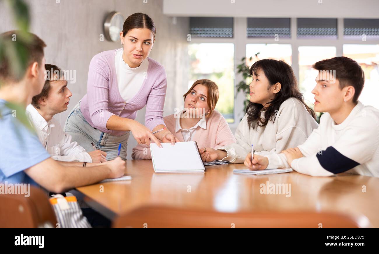Young female teacher giving lecture to group of students Stock Photo ...