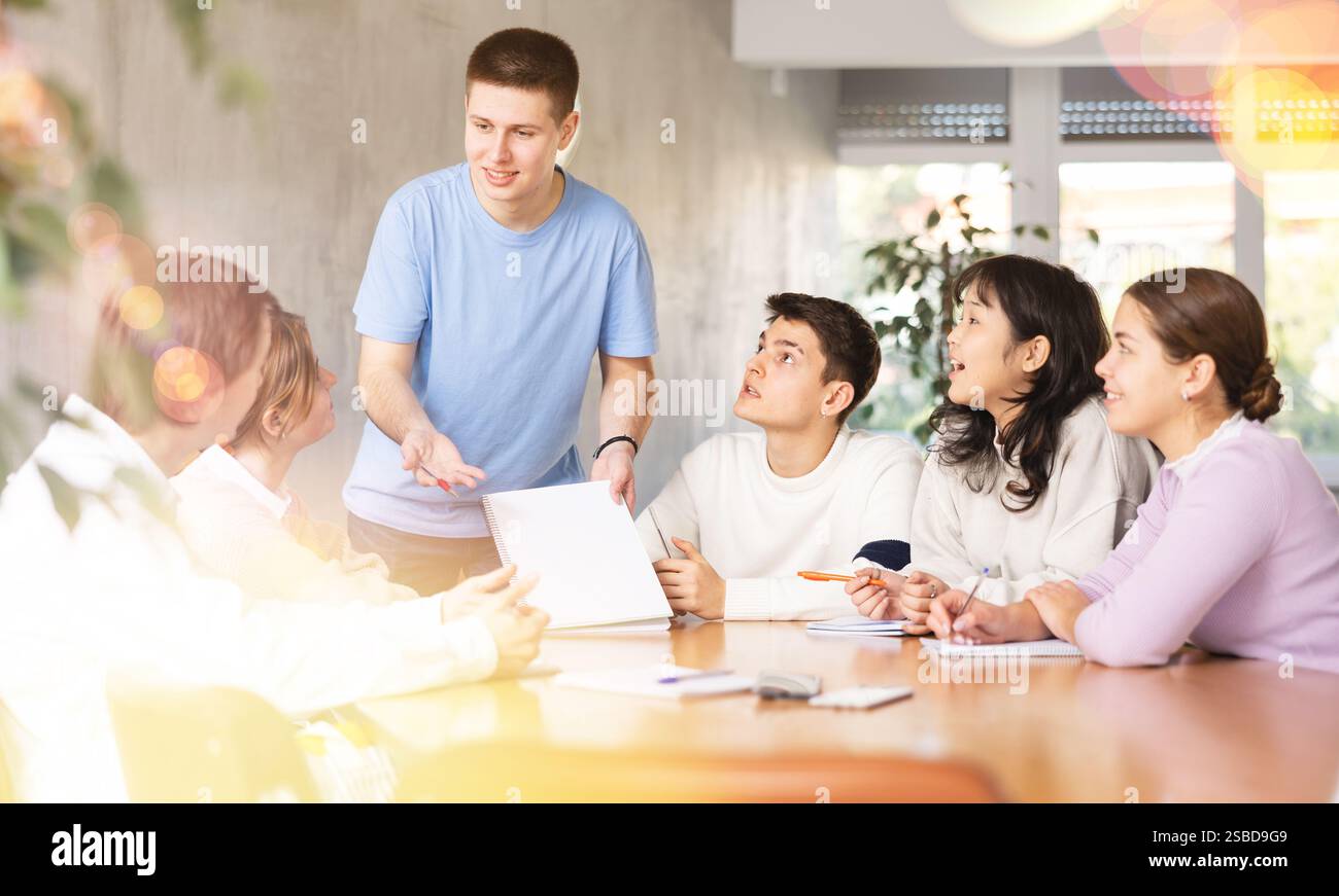 Young male teacher giving lecture to group of students Stock Photo - Alamy