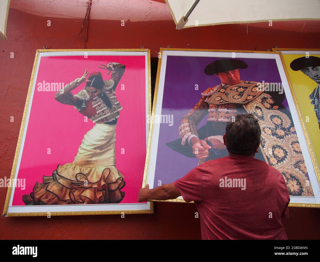 Traditional posters of bullfighters and Majas hung on the facades ...
