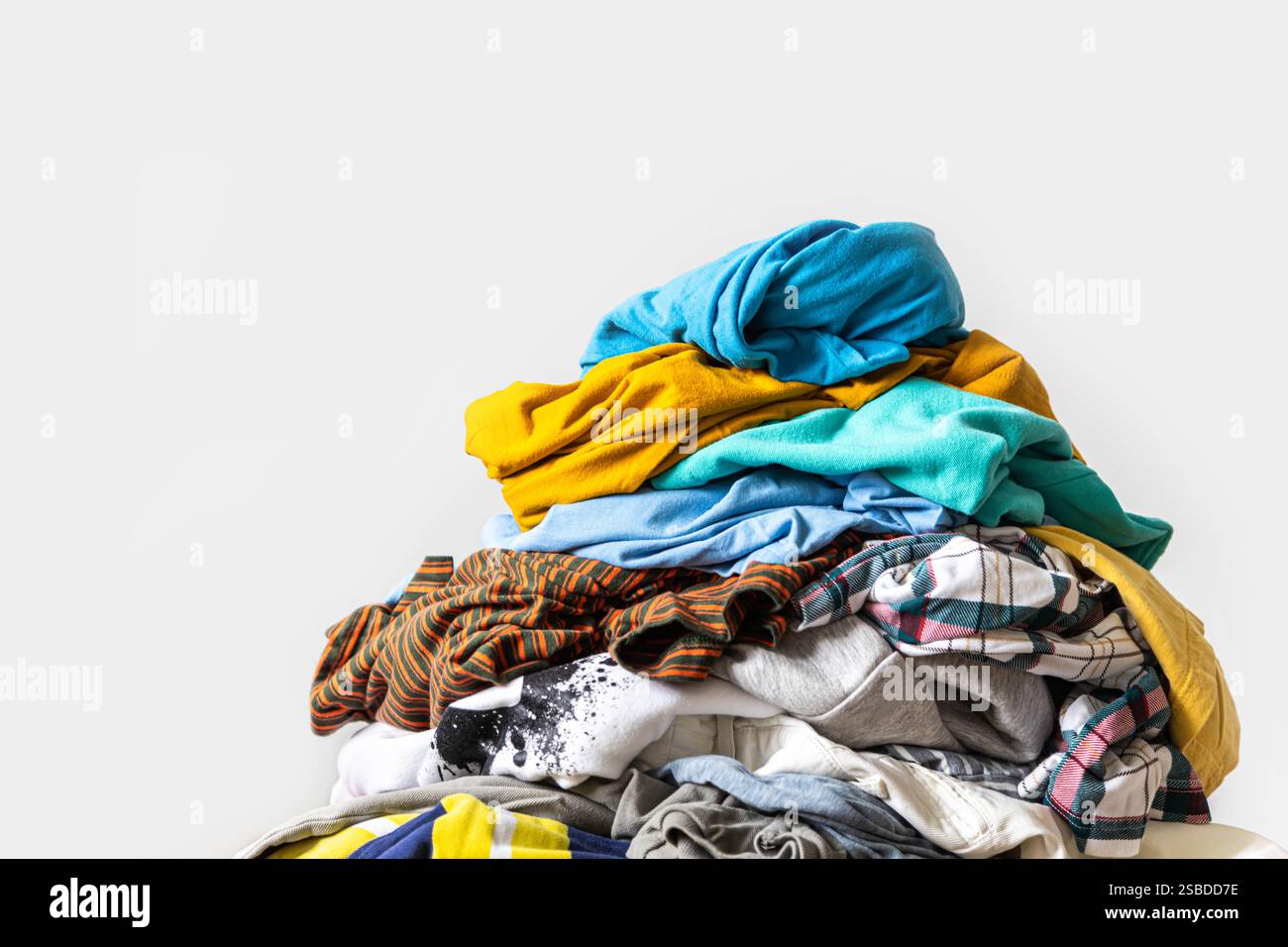 Pile of unfolded dirty clothes for laundry on the chair. Heap of used ...