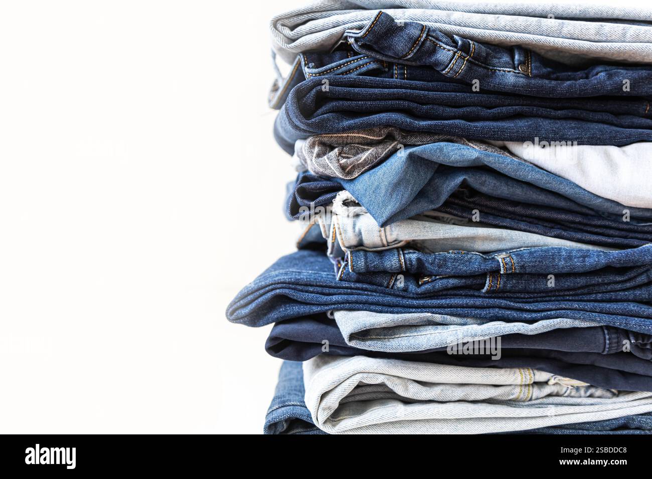 Stack of various shades of blue jeans on white background Stock Photo ...