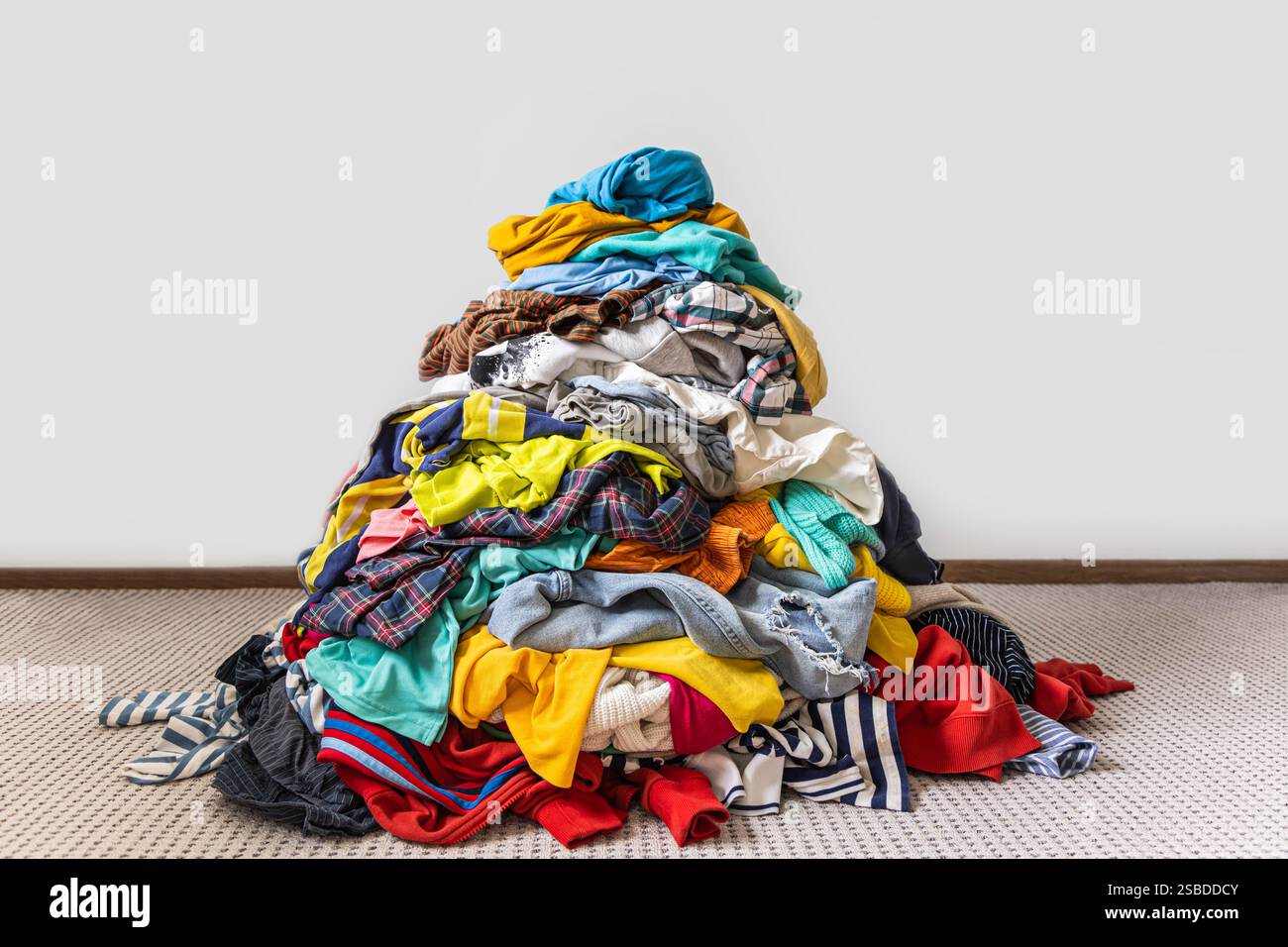 Pile of unfolded dirty clothes for laundry on the chair. Heap of used ...