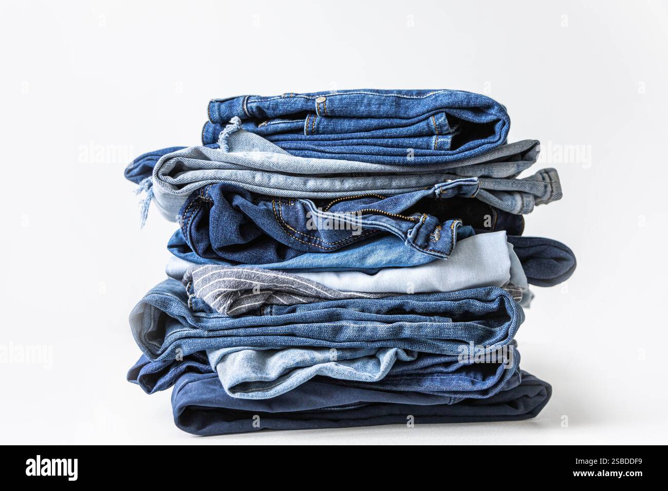 Stack of various shades of blue jeans on white background Stock Photo ...