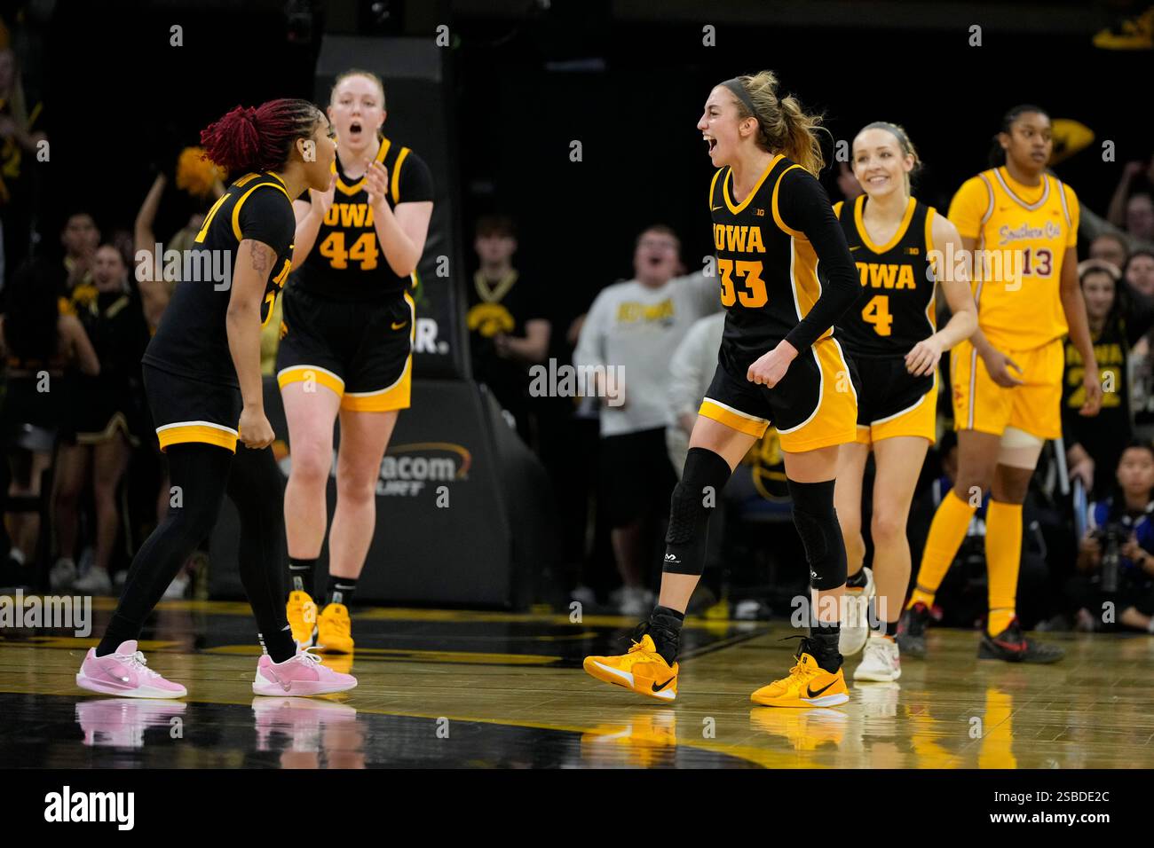 Iowa guard Lucy Olsen (33) celebrates with teammates during the second ...